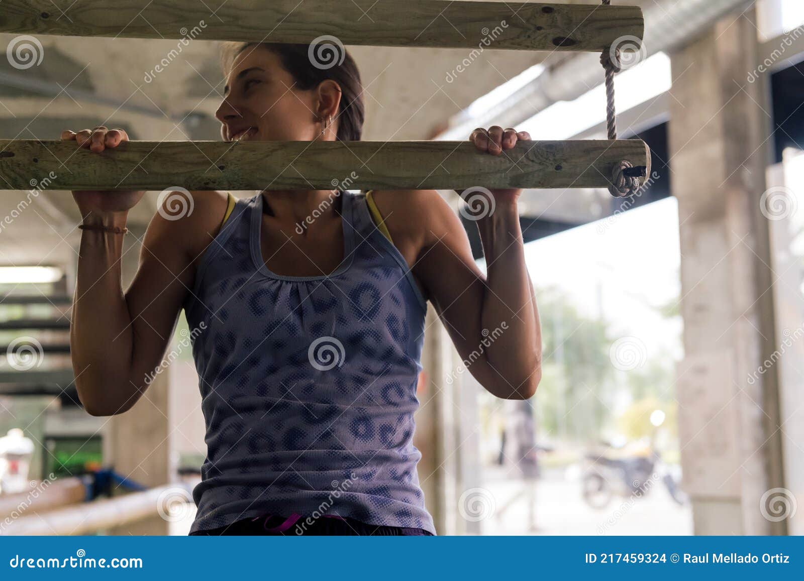Female Athlete Trains Strength by Doing Pull-ups Stock Photo - Image of ...