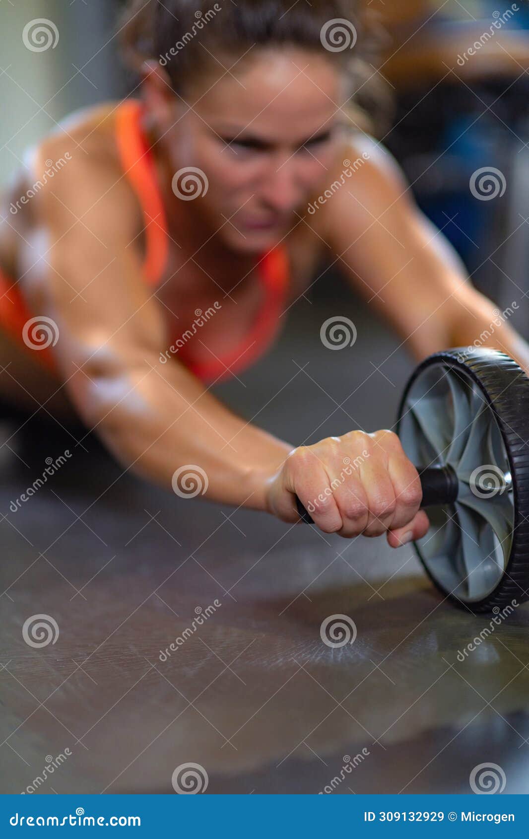 Female Athlete Using Abs Roller Wheel, Engaging Core Muscles for ...