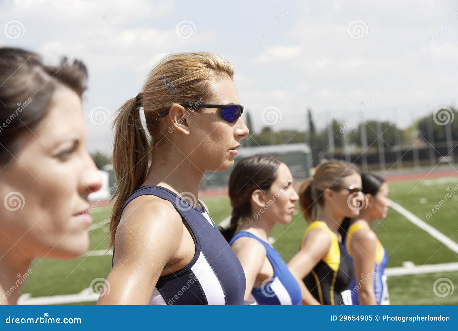 Female Athletes Standing in Line on Field Stock Image - Image of ...
