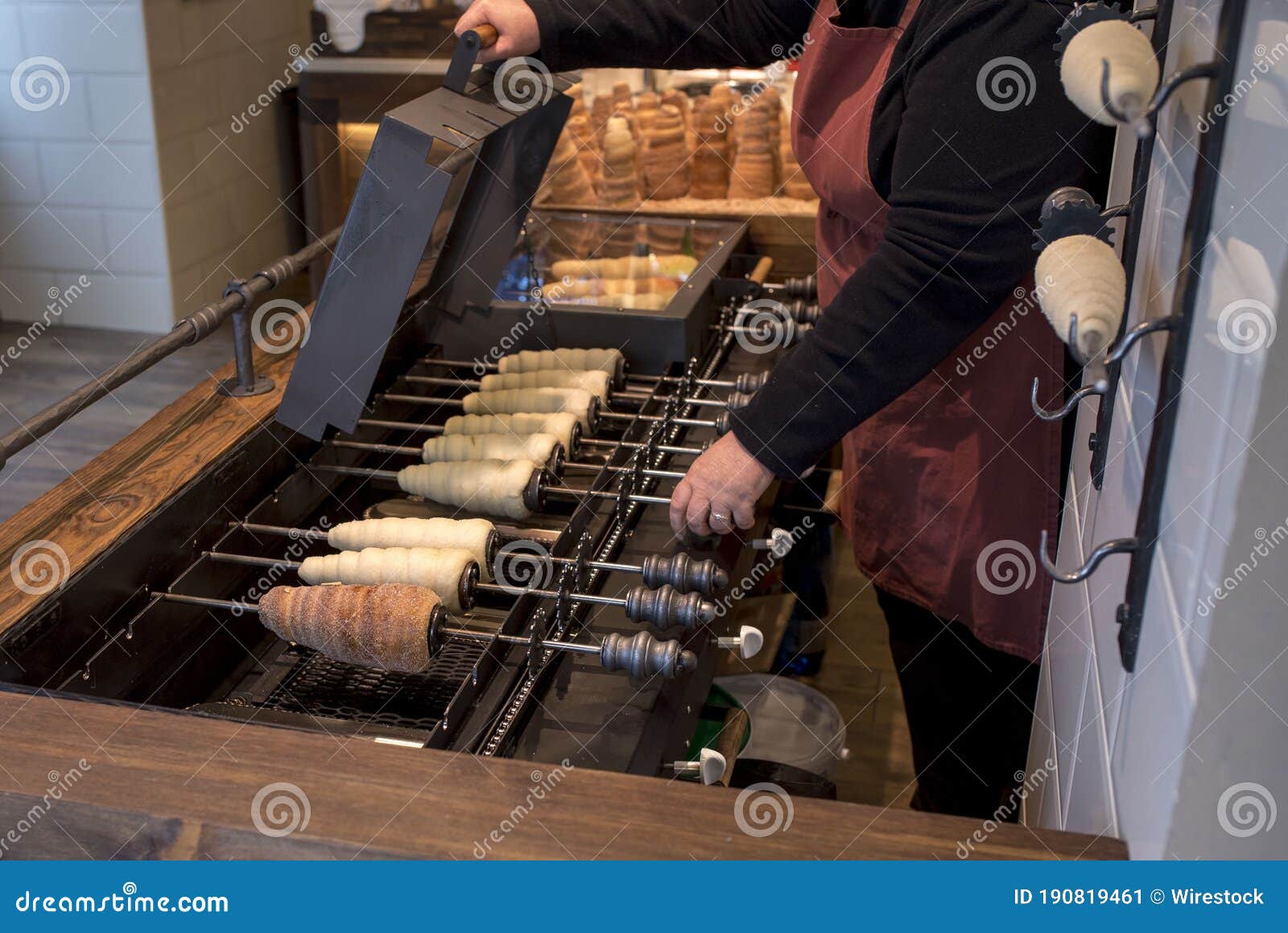 Female Baker Baking Traditional Chimney Cakes on Roll Spinning Over Hot ...