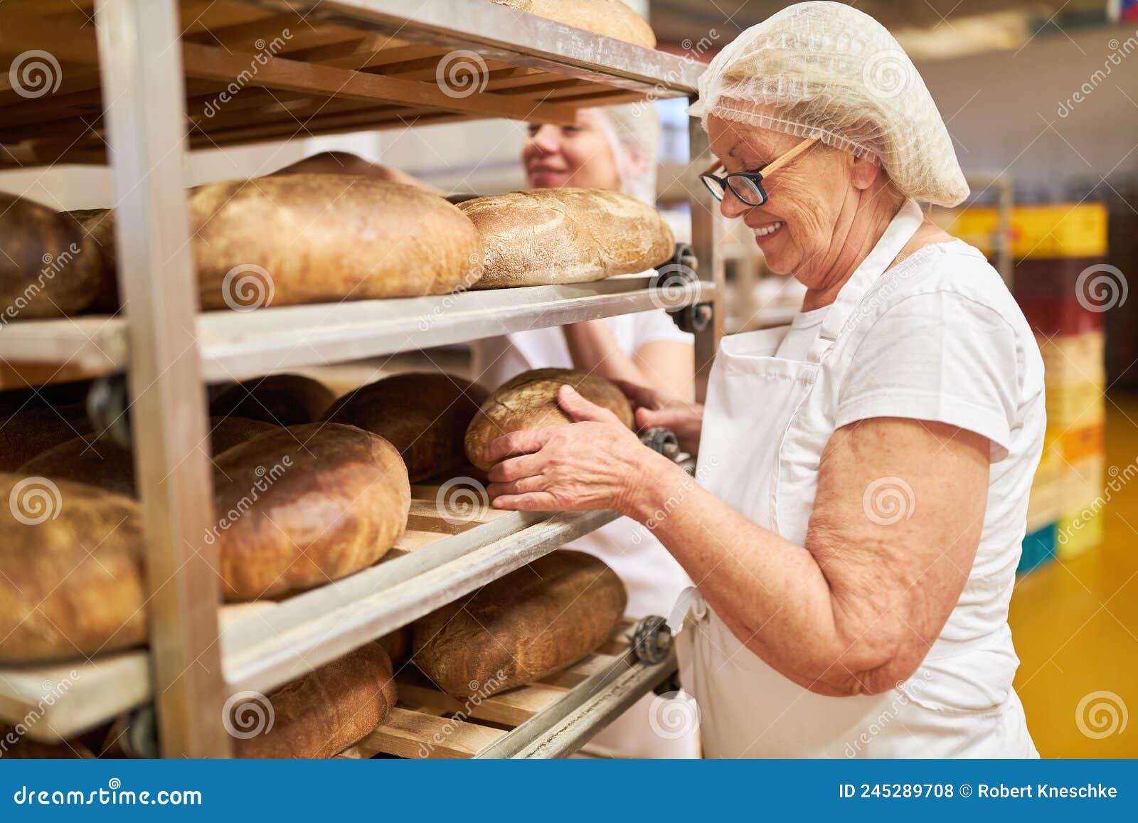 Female Baker Checking the Quality of Baked Bread Stock Photo - Image of ...