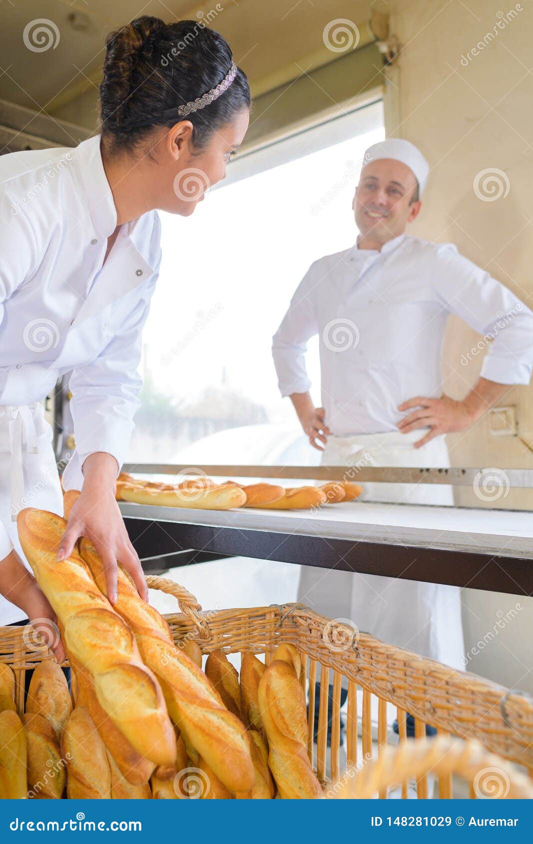 Female Baker Loading Bread into Basket Stock Image - Image of ...