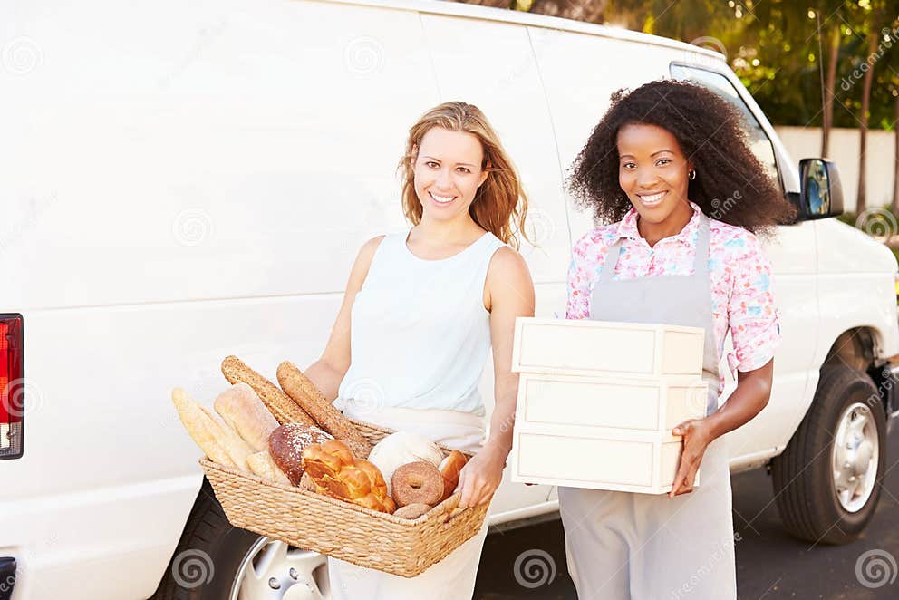 Female Bakers Unloading Bread and Cakes from Van Stock Photo - Image of ...