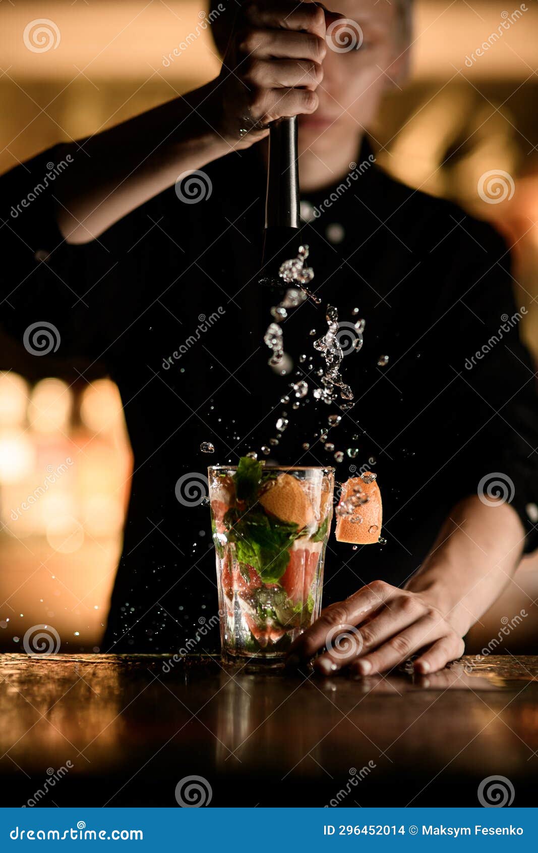 Female Bartender Breaks Ice in a Glass with a Drink Using a Mulder ...