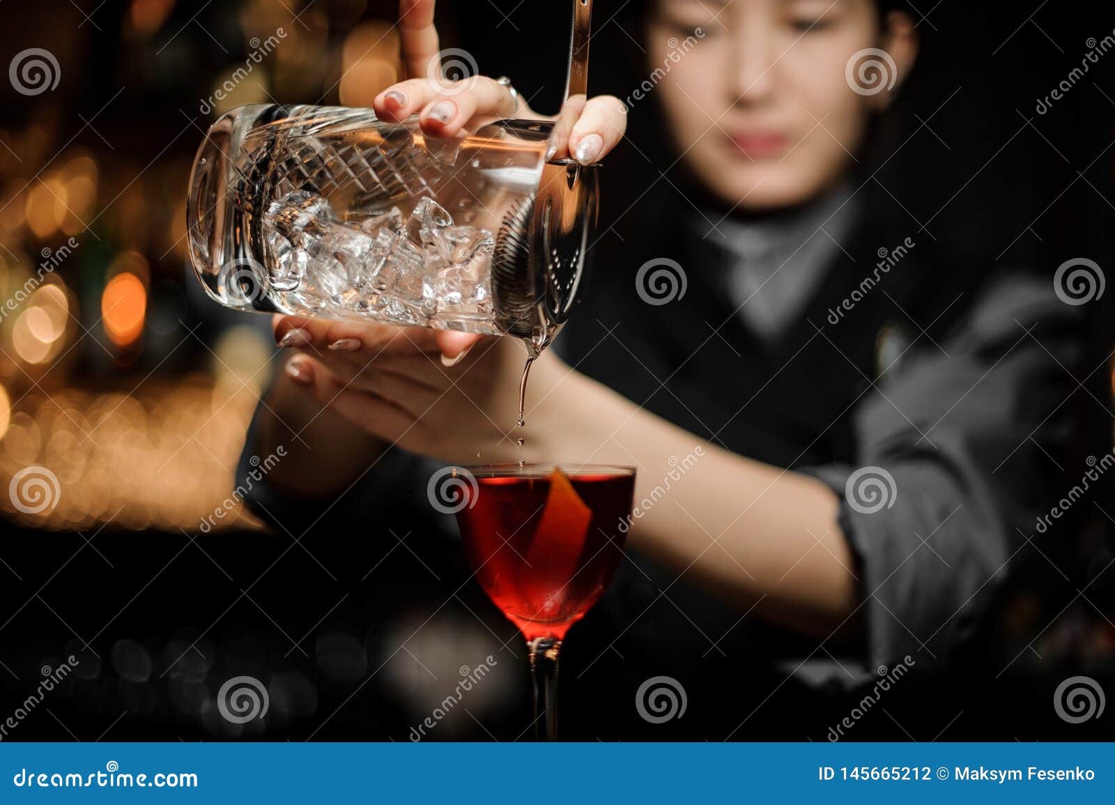 Female Bartender Pouring Alcohol Cocktail Using Strainer Stock Photo ...