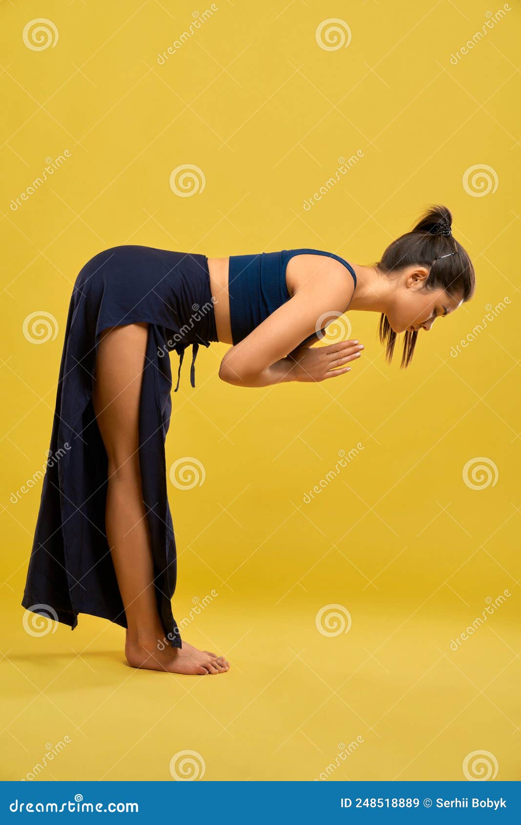 Female Bending Forward With Folding Hands Together Indoor Stock Image