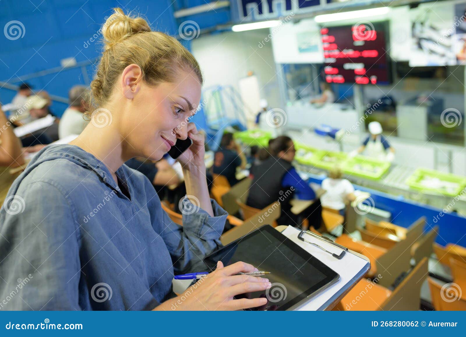 Female Bidder Using Tablet in Auction Hall Stock Photo - Image of ...