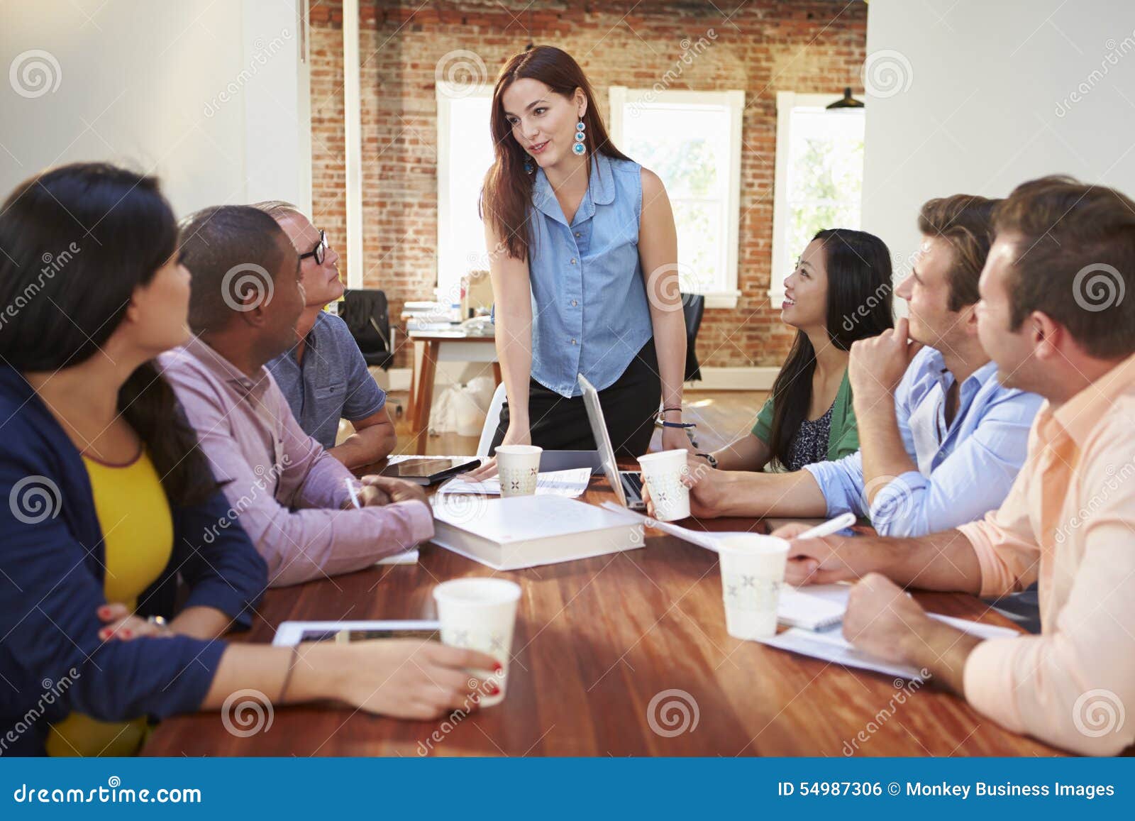 Female Boss Addressing Office Workers at Meeting Stock Photo - Image of ...