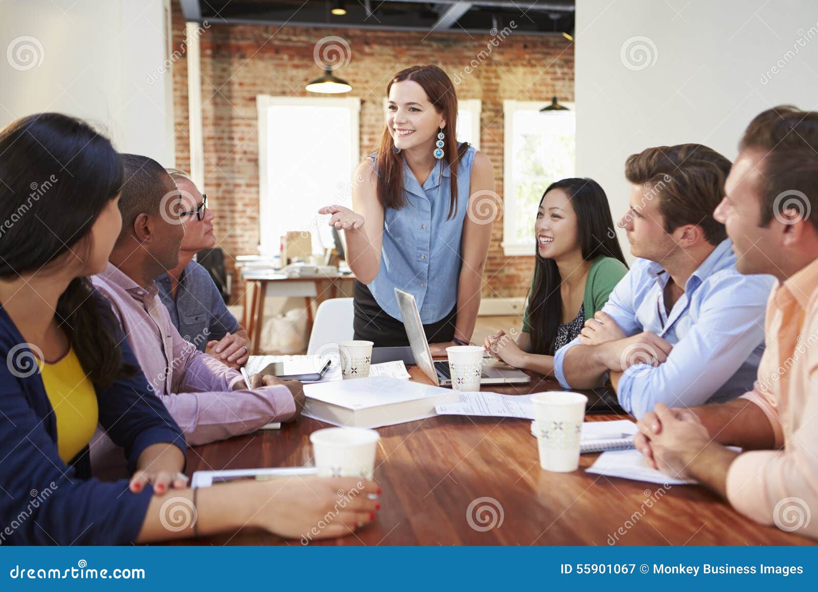 Female Boss Addressing Office Workers at Meeting Stock Image - Image of ...