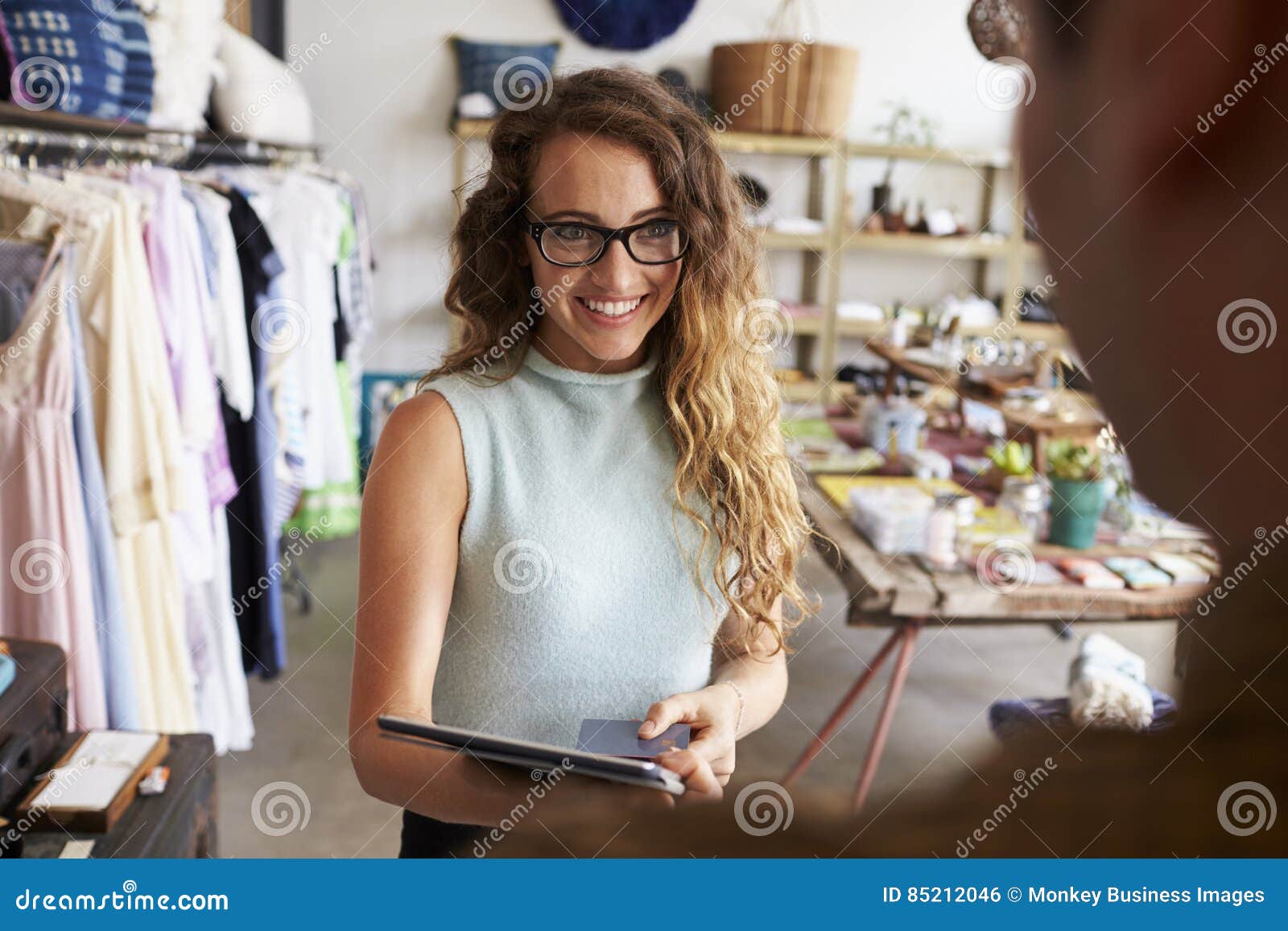 Female Boutique Manager Greeting Client in Shop Stock Photo - Image of ...