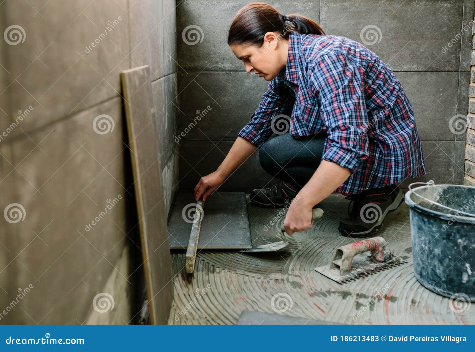 Female Bricklayer Checking Floor with a Level Stock Image - Image of ...