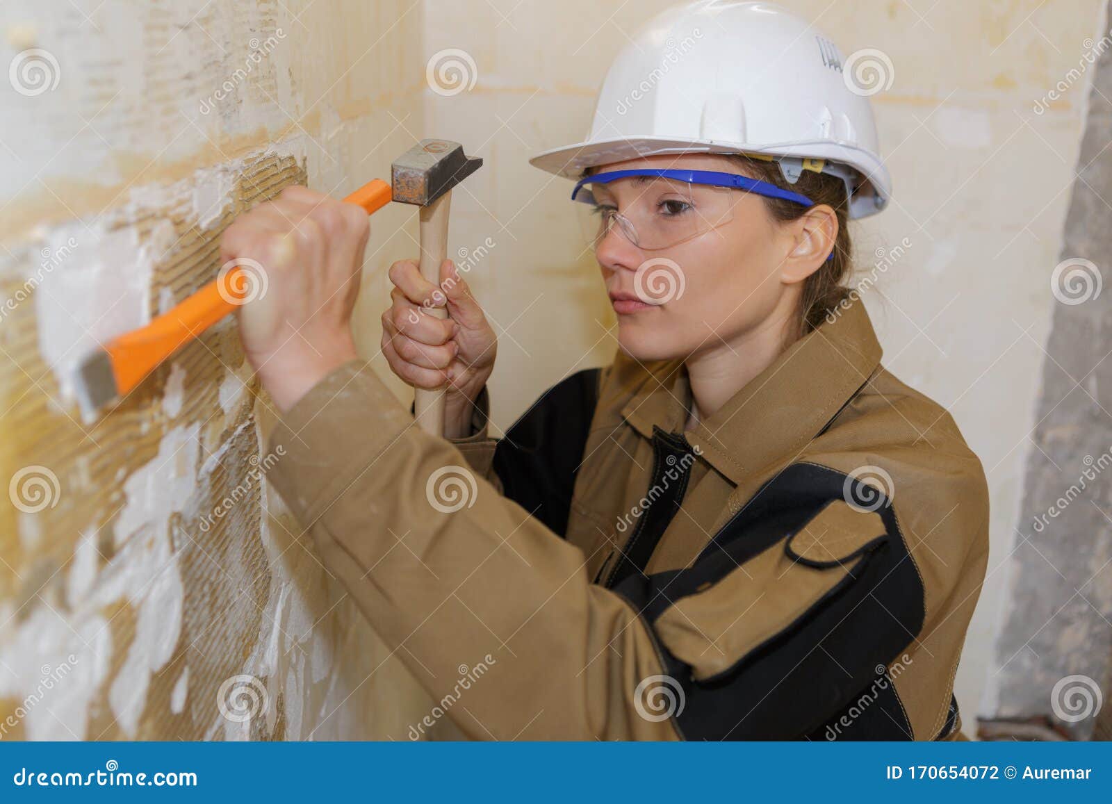 Female Builder Using Hammer and Chisel on Wall Stock Photo - Image of ...