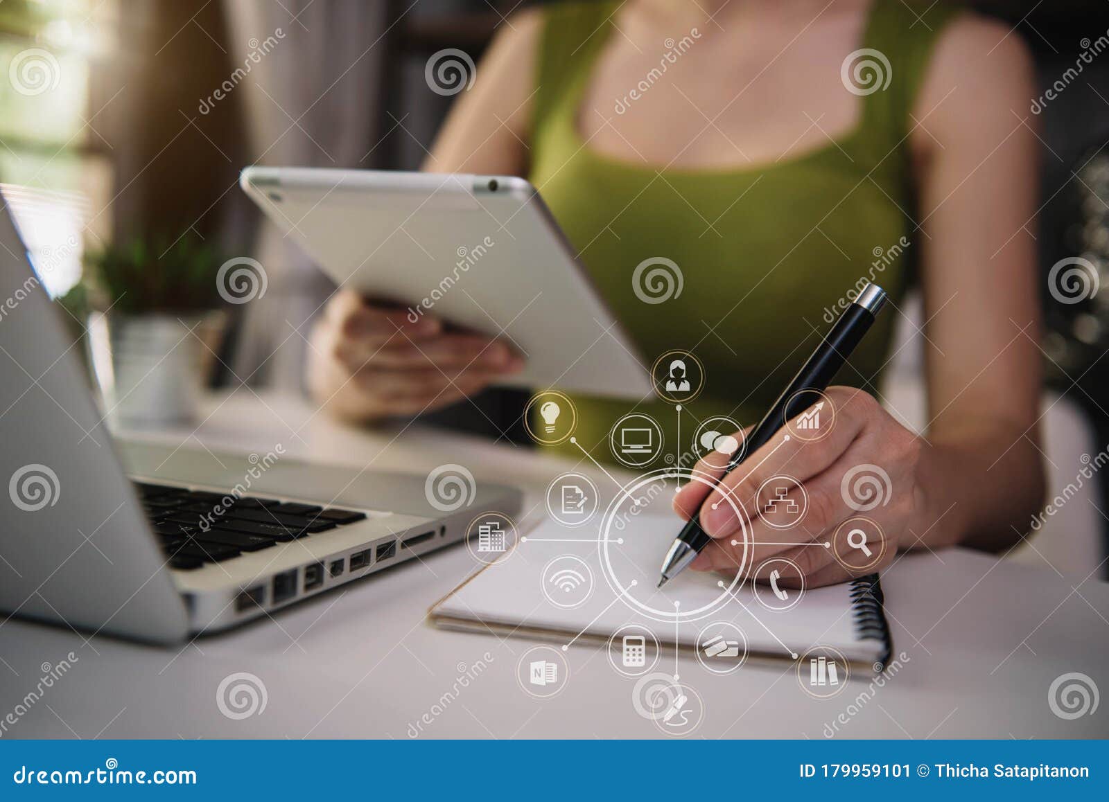 Female Businessman Use a Laptop Computer and Take Notes in the Notebook ...