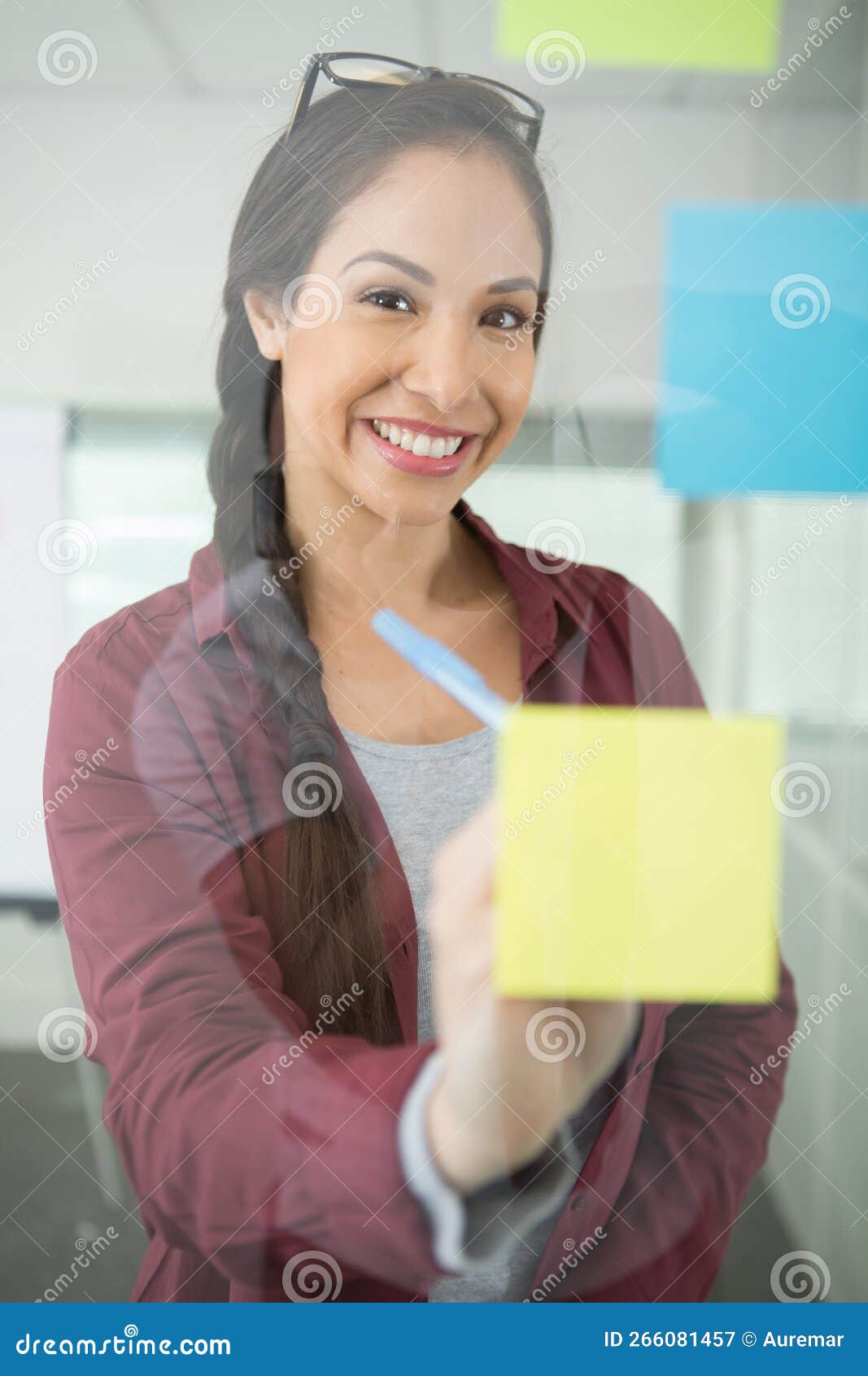 Female Businesswoman Smiling and Writing on Post-it Note Stock Image ...