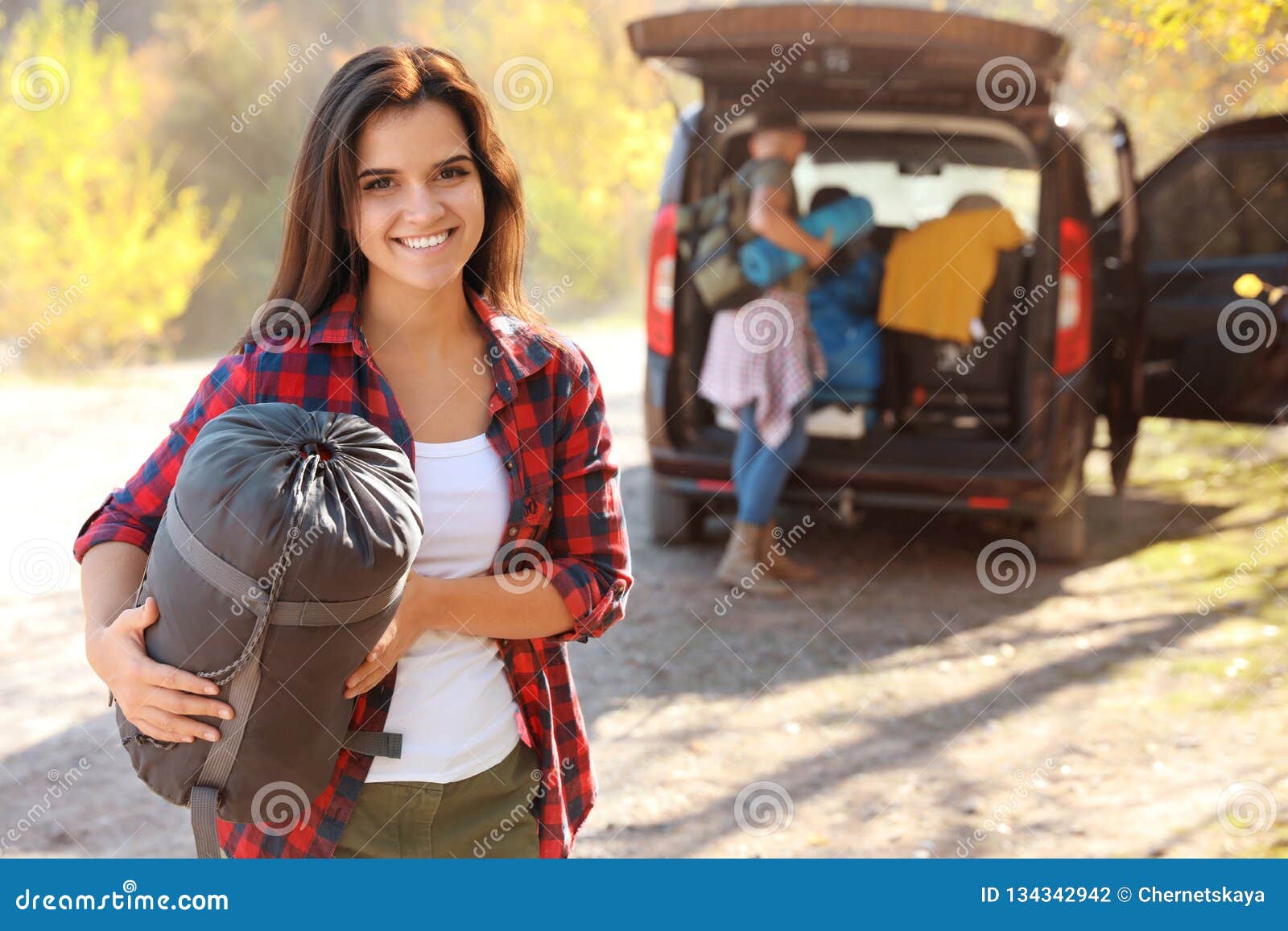Female Camper with Sleeping Bag Near Car Outdoors. Stock Photo - Image ...