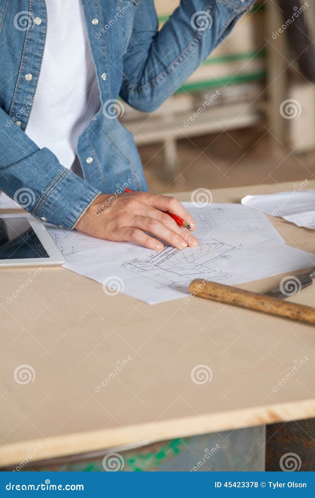 Female Carpenter with Blueprint at Table Stock Photo - Image of table ...