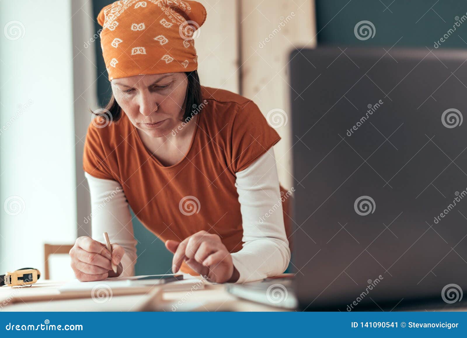 Female Carpenter Doing Financial Calculation Stock Image - Image of ...