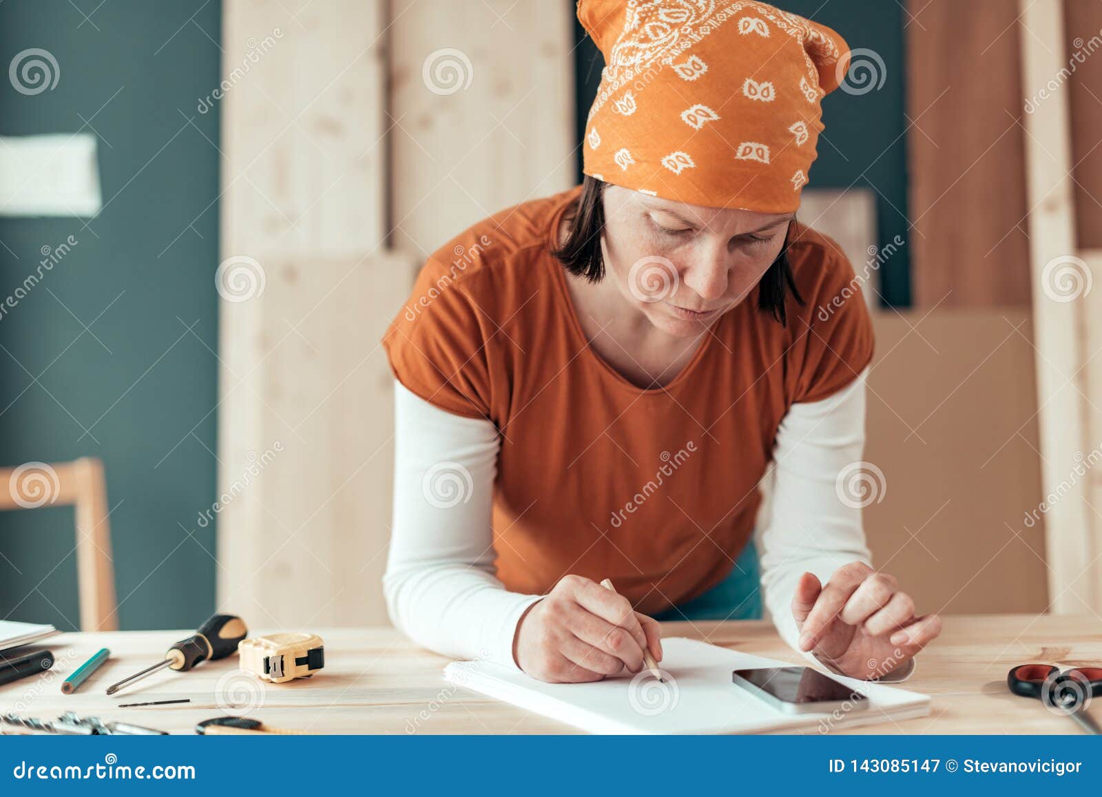 Female Carpenter Doing Financial Calculation Stock Image - Image of ...