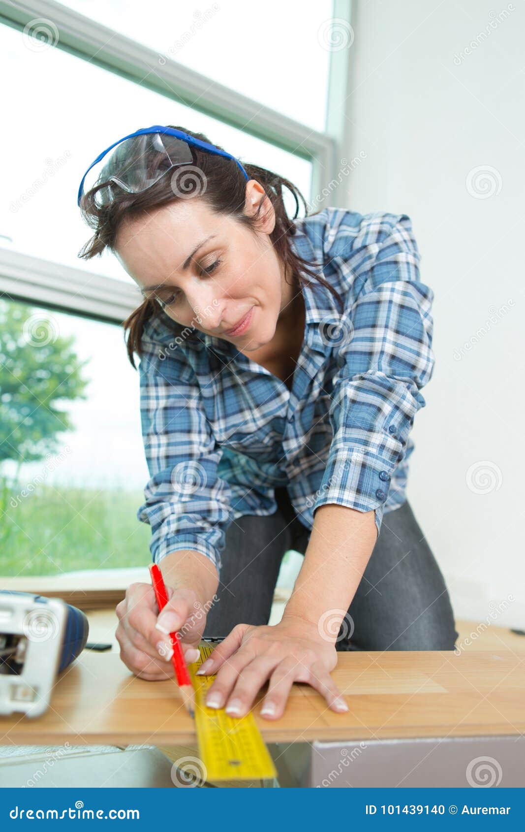 Female Carpenter Taking Measurements Board Stock Photo - Image of ...