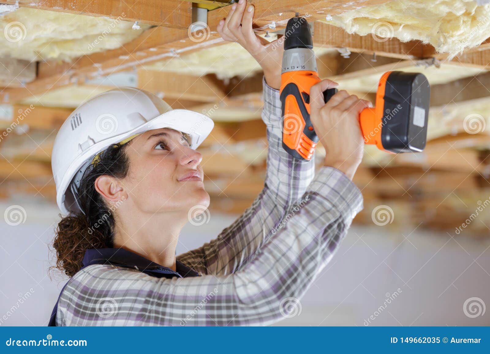 Female Carpenter Using Drill on Wood Structure Stock Image - Image of ...