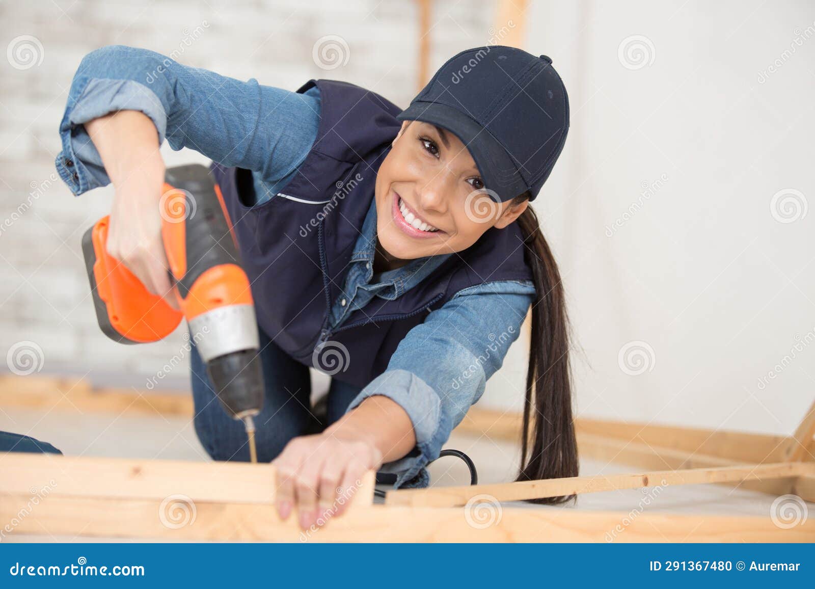 Female Carpenter Using Electric Drill Stock Photo - Image of ...