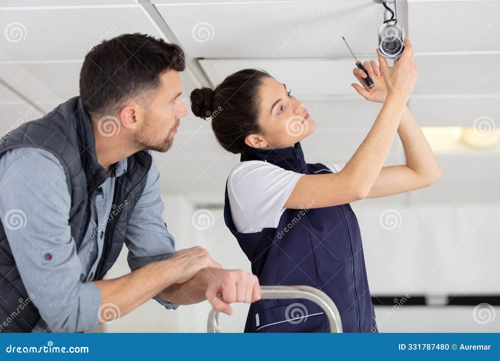 Female Cctv Installer Hinstalling Security Camera Stock Photo - Image ...