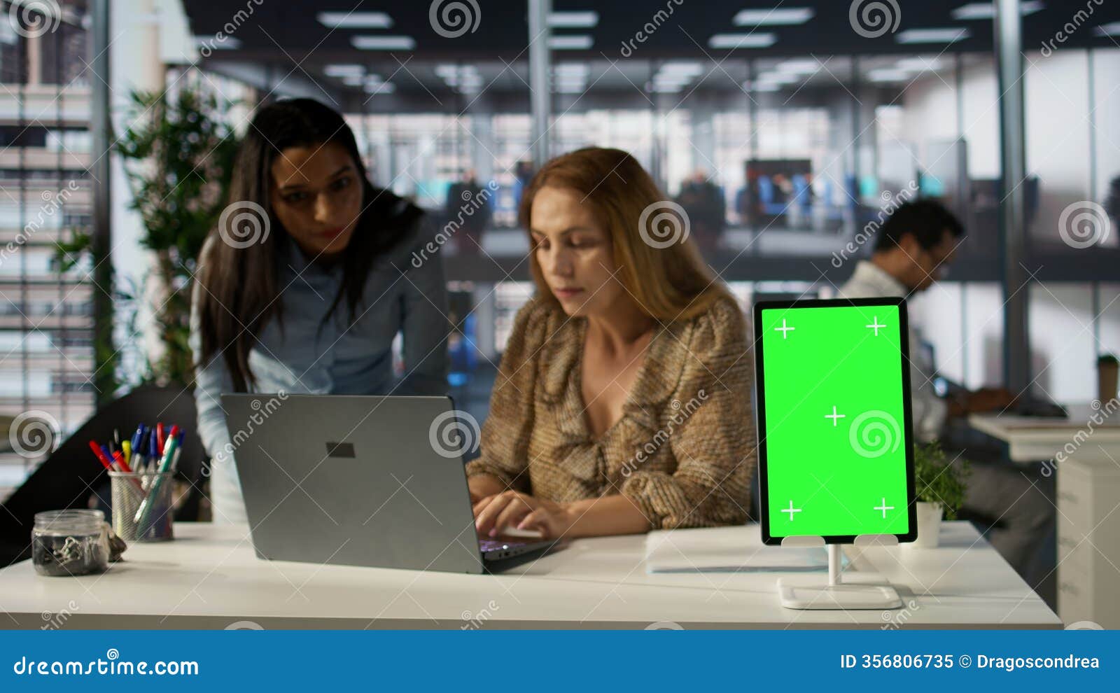 Female CEO Engaging in Project Management Using Green Screen To Set ...