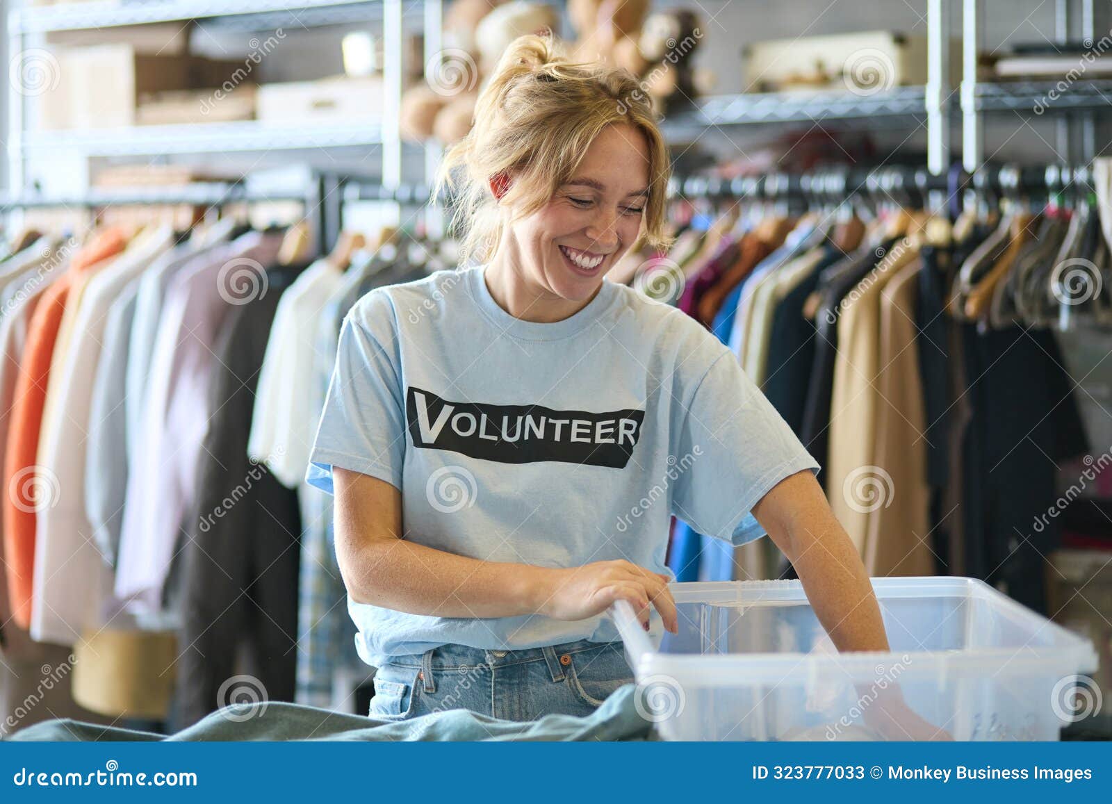 Female Charity Worker Sorting Clothing Donations at Thrift Store Stock ...