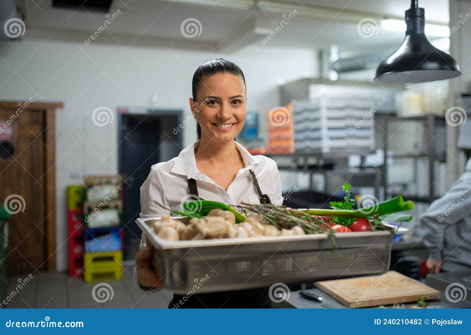 Female Chef Carrying Tray with Fresh Vegetables and Looking at Camera ...