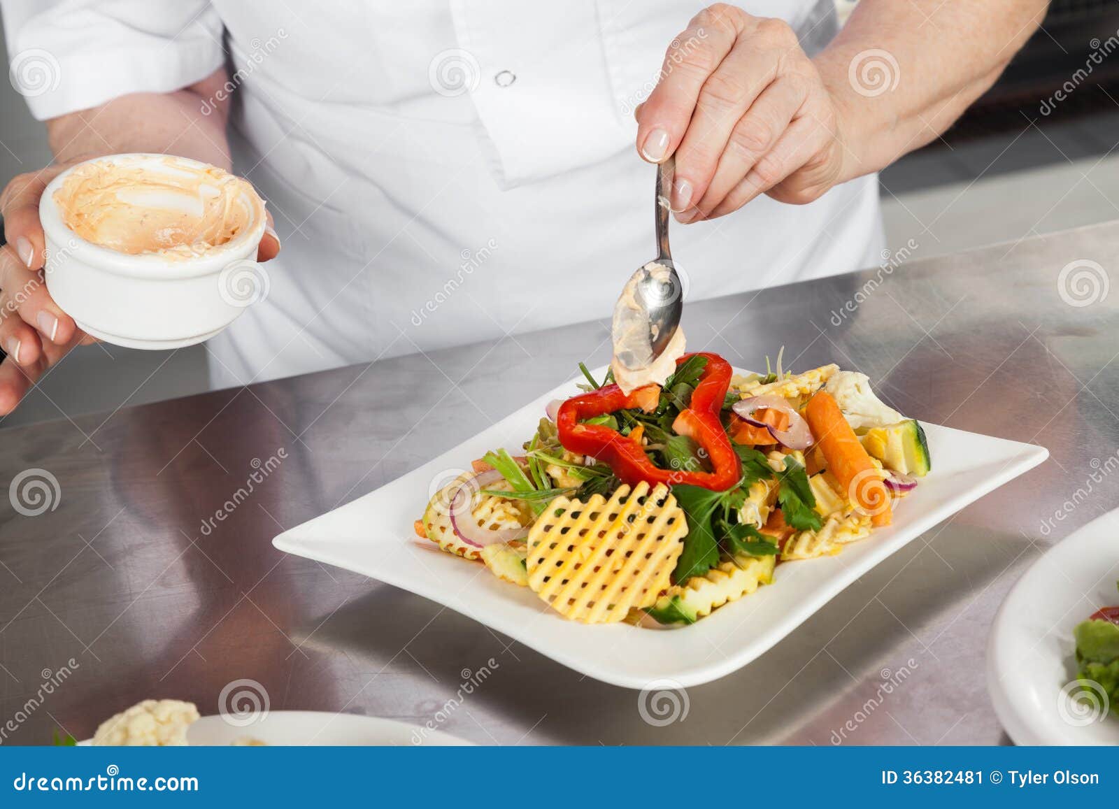 Female Chef Garnishing Dish at Counter Stock Image - Image of cream ...