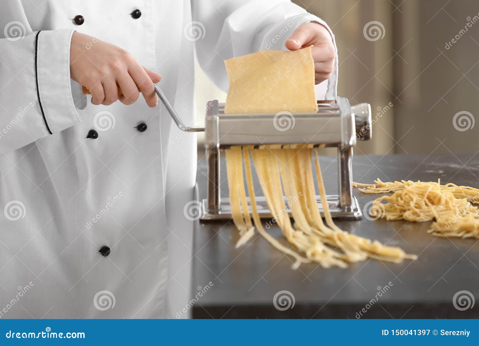 Female Chef Making Noodles with Pasta Machine at Table Stock Image ...