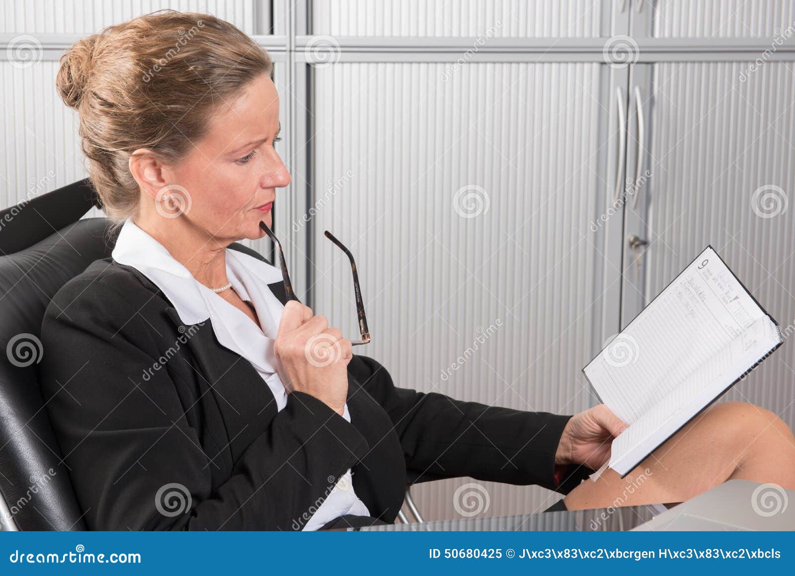 Female Chef in the Office Looking into Calendar Stock Image - Image of ...