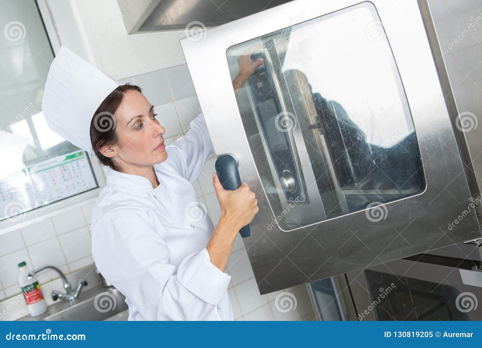 Female Chef Opening Oven Door Stock Image - Image of restaurant, person ...