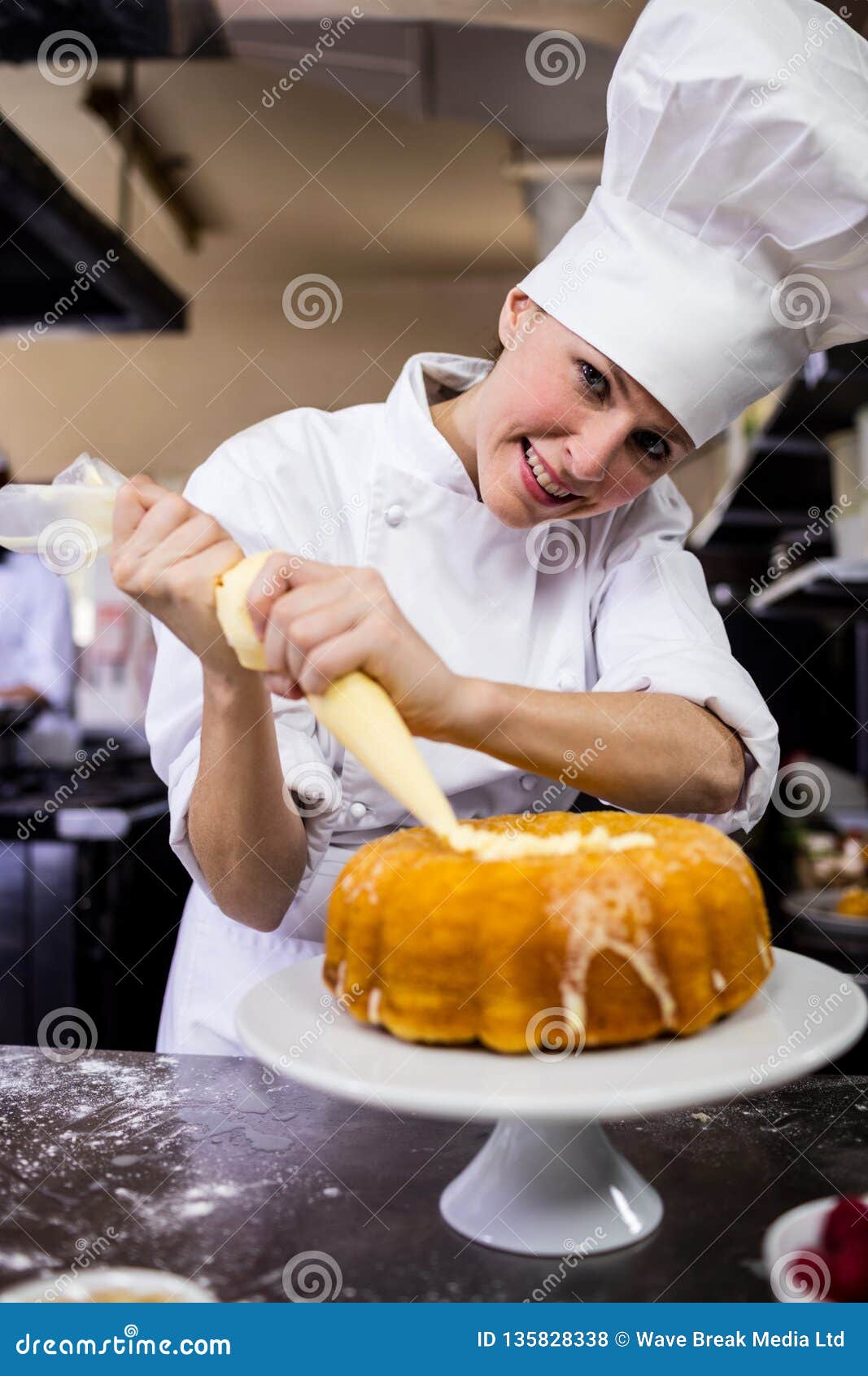 Female Chef Piping a Cake in Kitchen Stock Photo - Image of chefs ...