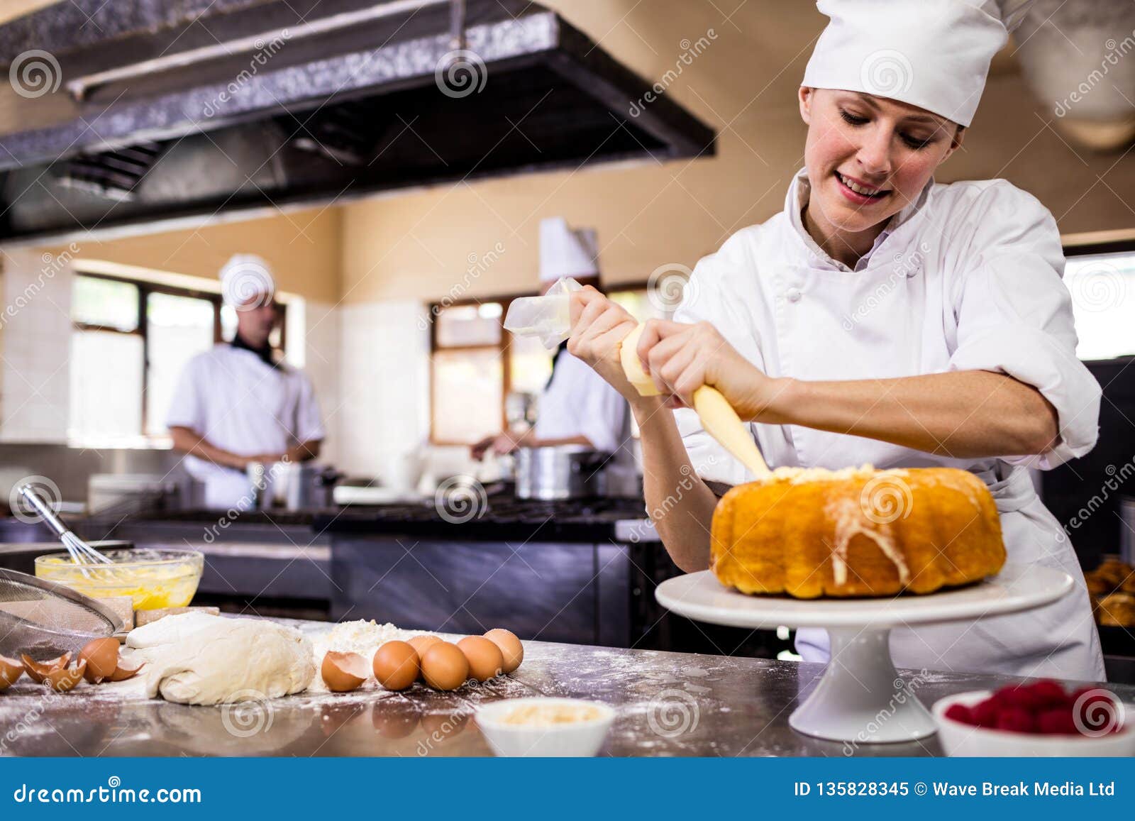 Female Chef Piping a Cake in Kitchen Stock Image - Image of standing ...