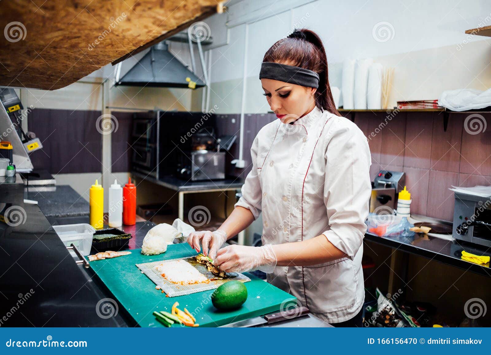 Female Chef Preparing a Sushi Restaurant in the Kitchen Stock Photo ...