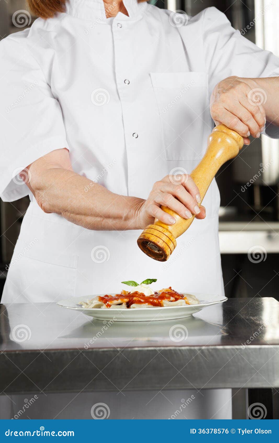 Female Chef Seasoning Dish with Pepper Stock Photo - Image of mill ...
