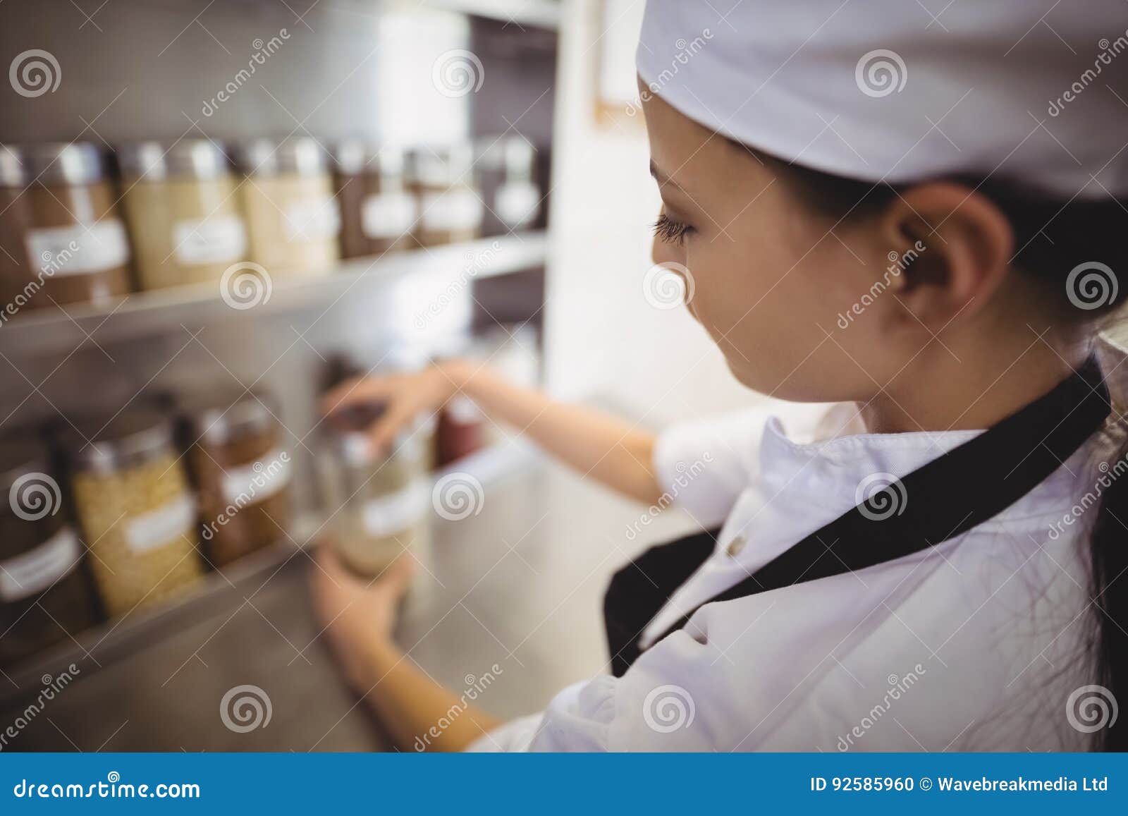 Female Chef Selecting a Spice Jar in the Commercial Kitchen Stock Photo ...