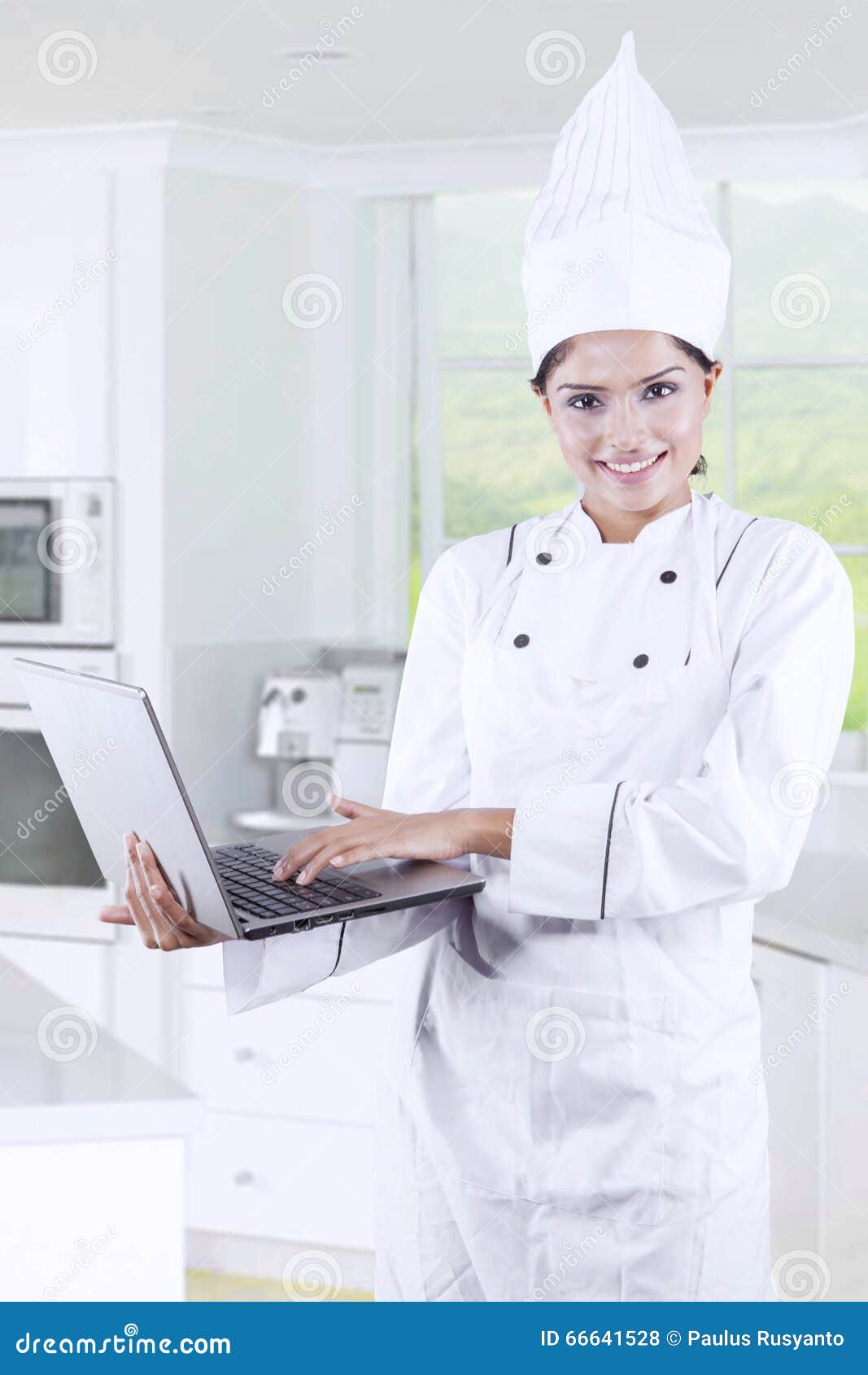 Female Chef Typing on a Laptop Stock Photo - Image of cooking, girl ...