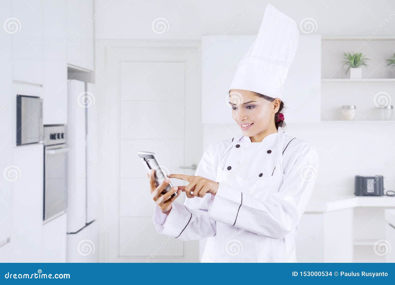 Female Chef Using a Phone in the Kitchen Stock Photo - Image of ...