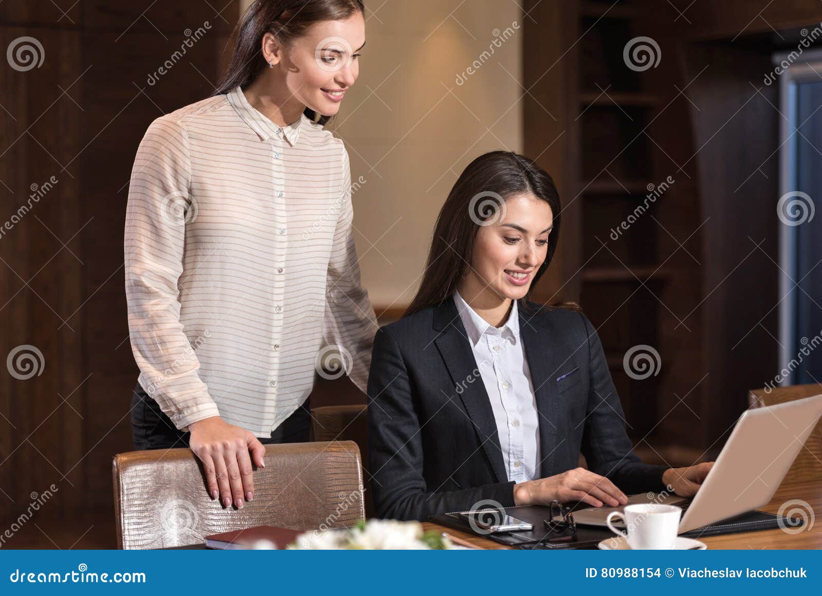 Female Colleagues Cooperating in an Office Stock Photo - Image of ...