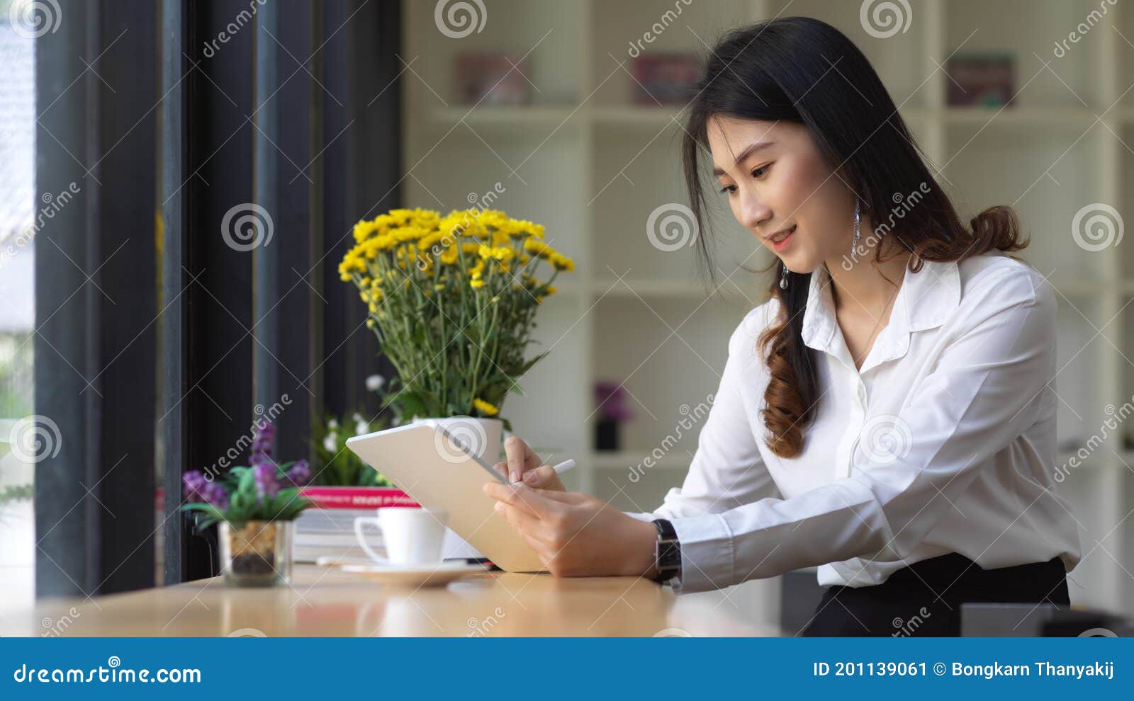 Female College Student Doing Homework with Tablet on Table in Library ...