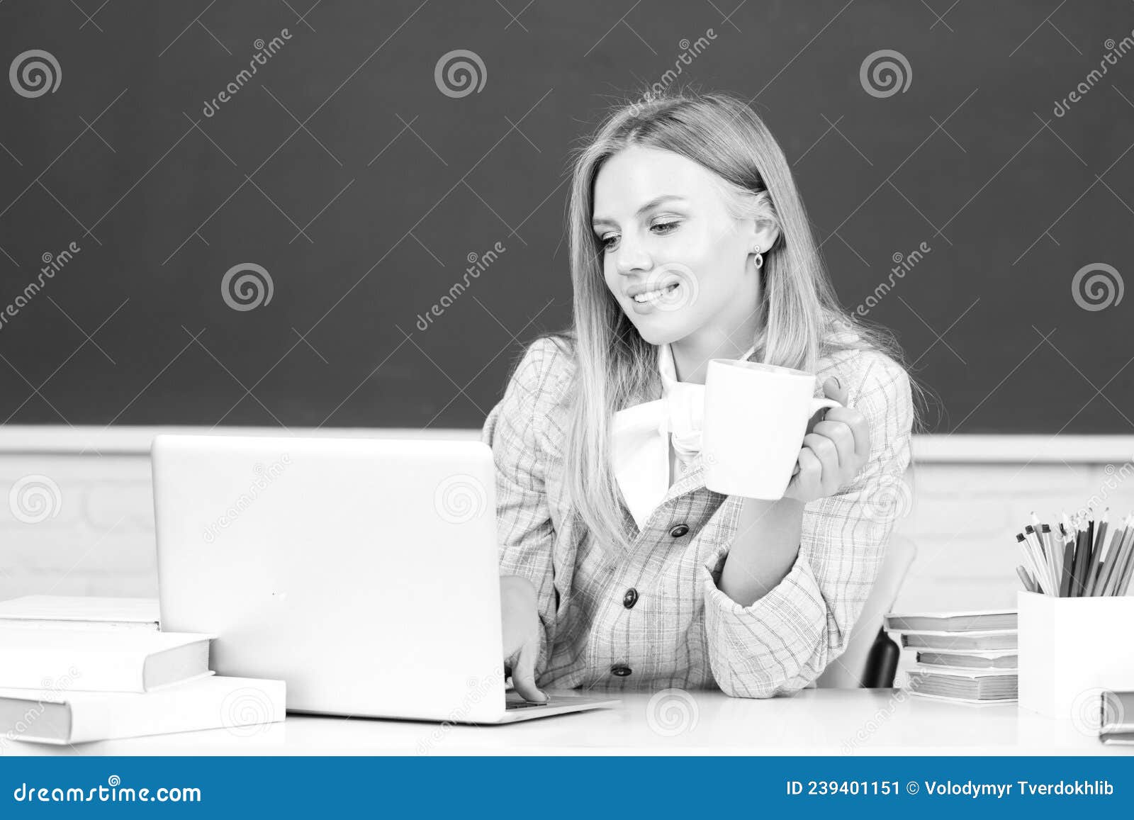 Female College Student Drinking Coffee or Tea, Working on a Laptop in ...