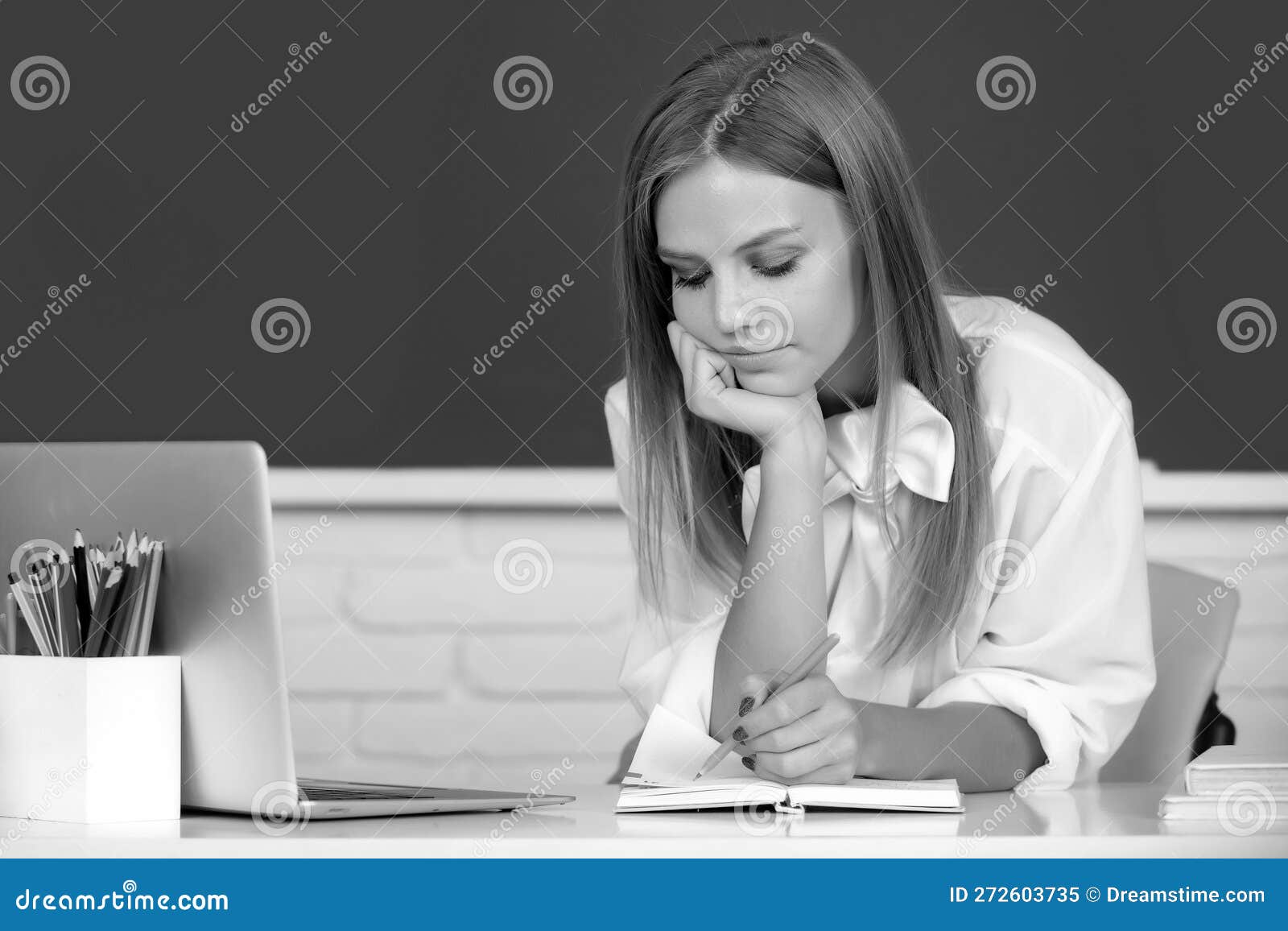 Female College Student Working on a Laptop in Classroom, Preparing for ...