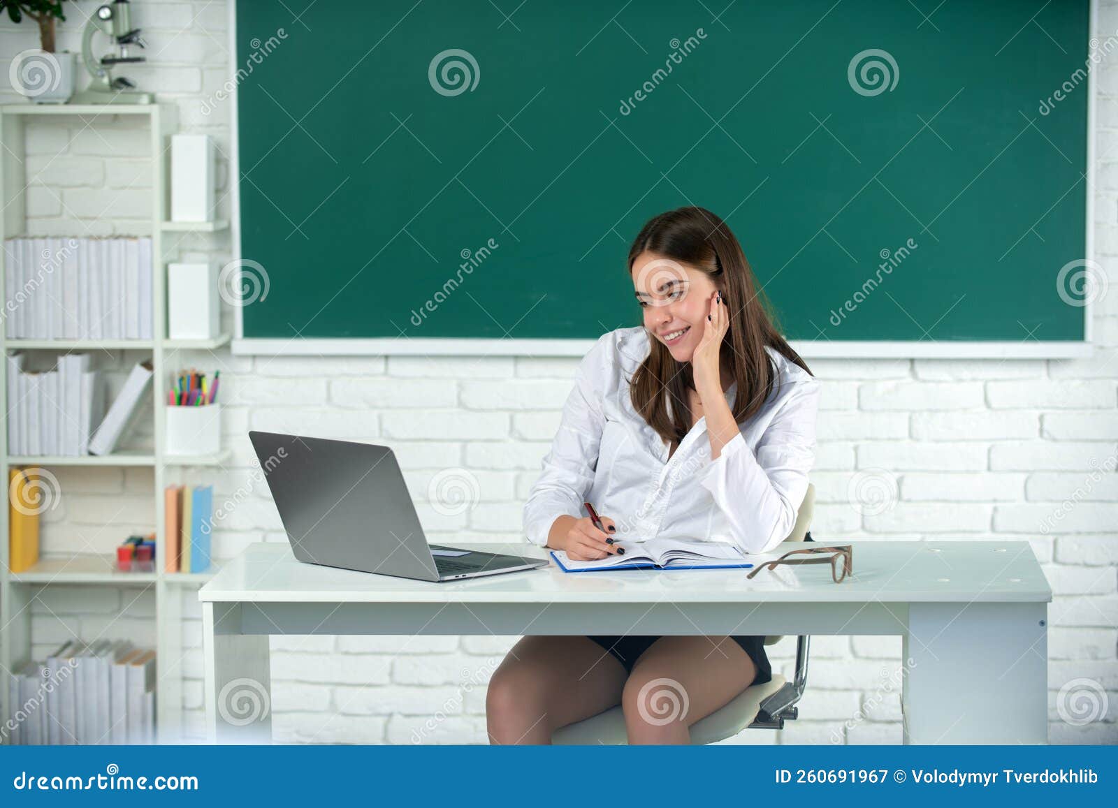 Female College Student Working on a Laptop in Classroom, Preparing for ...