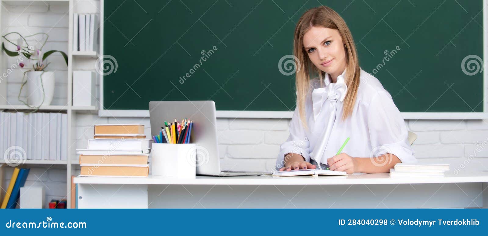 Female College Student Writing on Notebook in Classroom, Preparing for ...