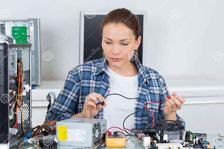 Female Computer Technician Using Multimeter Stock Image - Image of ...