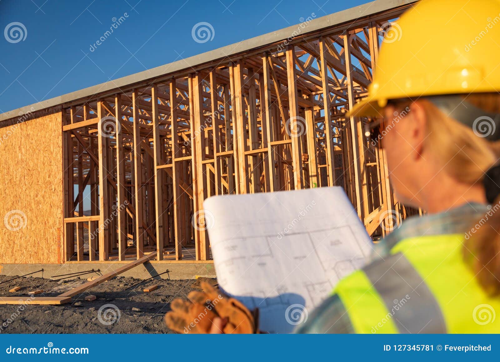 Female Construction Worker with House Plans at Construciton Site Stock ...
