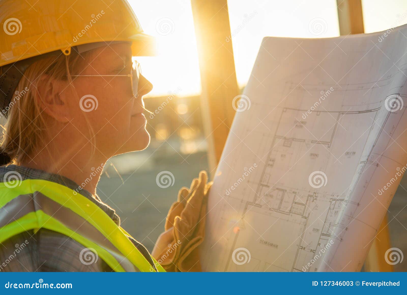 Female Construction Worker with House Plans at Construciton Site Stock ...