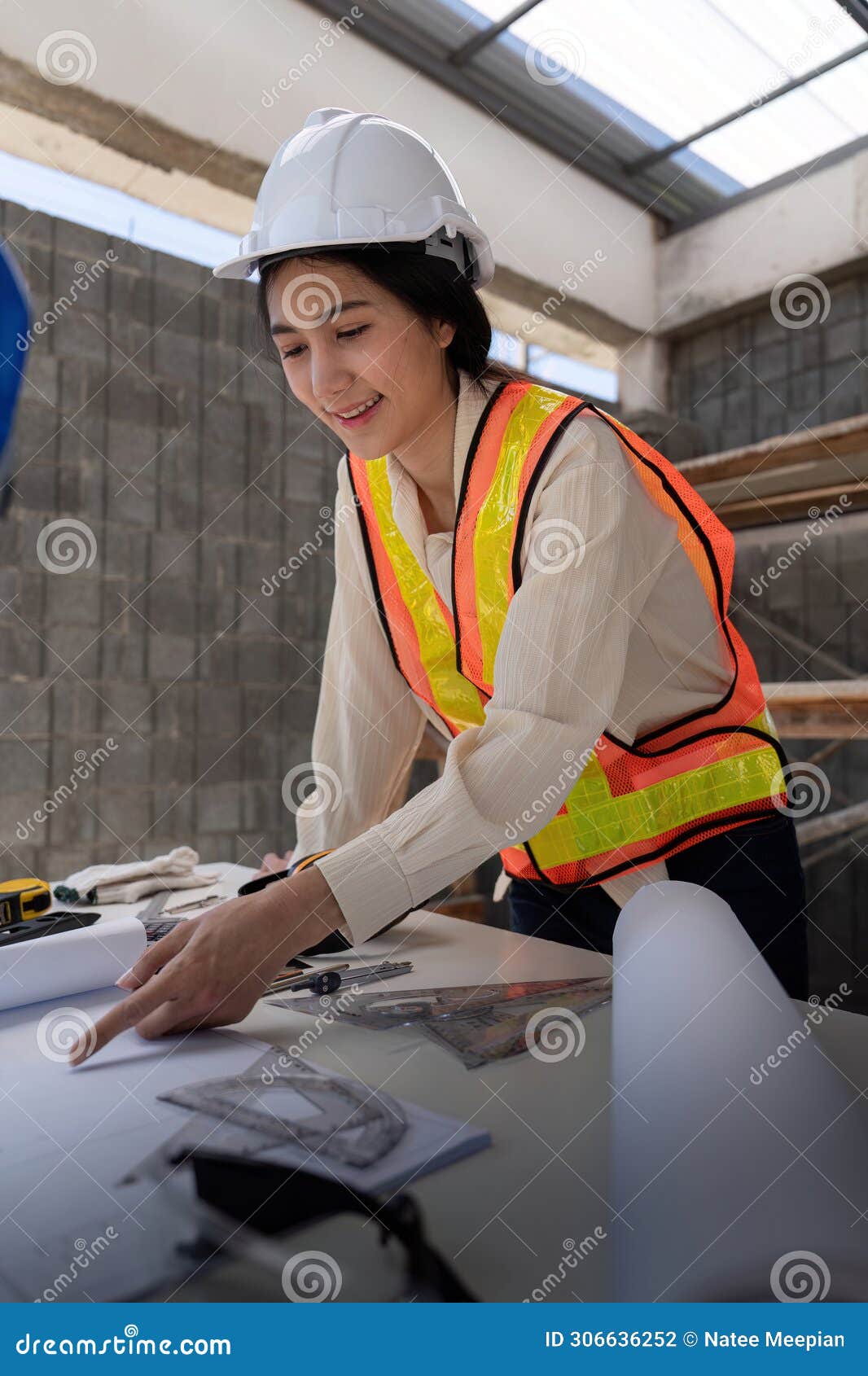 Female Construction Engineer. Architect with a Blueprint at a ...